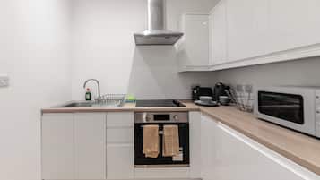 Um frigorífico, um micro-ondas, um forno, uma placa de cozinha