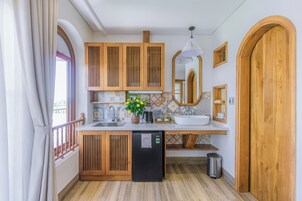 Cozinha moderna com armários de madeira, máquina de lavar louça embutida e uma pia grande.