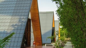Um edifício moderno com telhado inclinado e um caminho que o leva até ele.