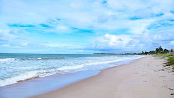 Na praia, areia branca, prática de mergulho livre no local