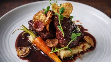 Prato com bife, legumes e acompanhamentos.