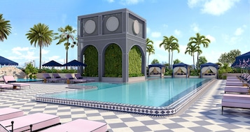 Uma área de piscina com piso xadrez, cadeiras de descanso e uma torre decorativa com aberturas em arco.