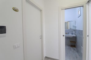 Uma porta branca com um interruptor de luz e um pequeno ornamento decorativo.