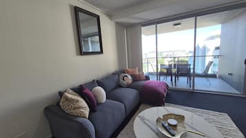 Apartamento Deluxe, vista para o rio | Sala de estar | Smart TV de 60 polegadas com canais digitais, Netflix
