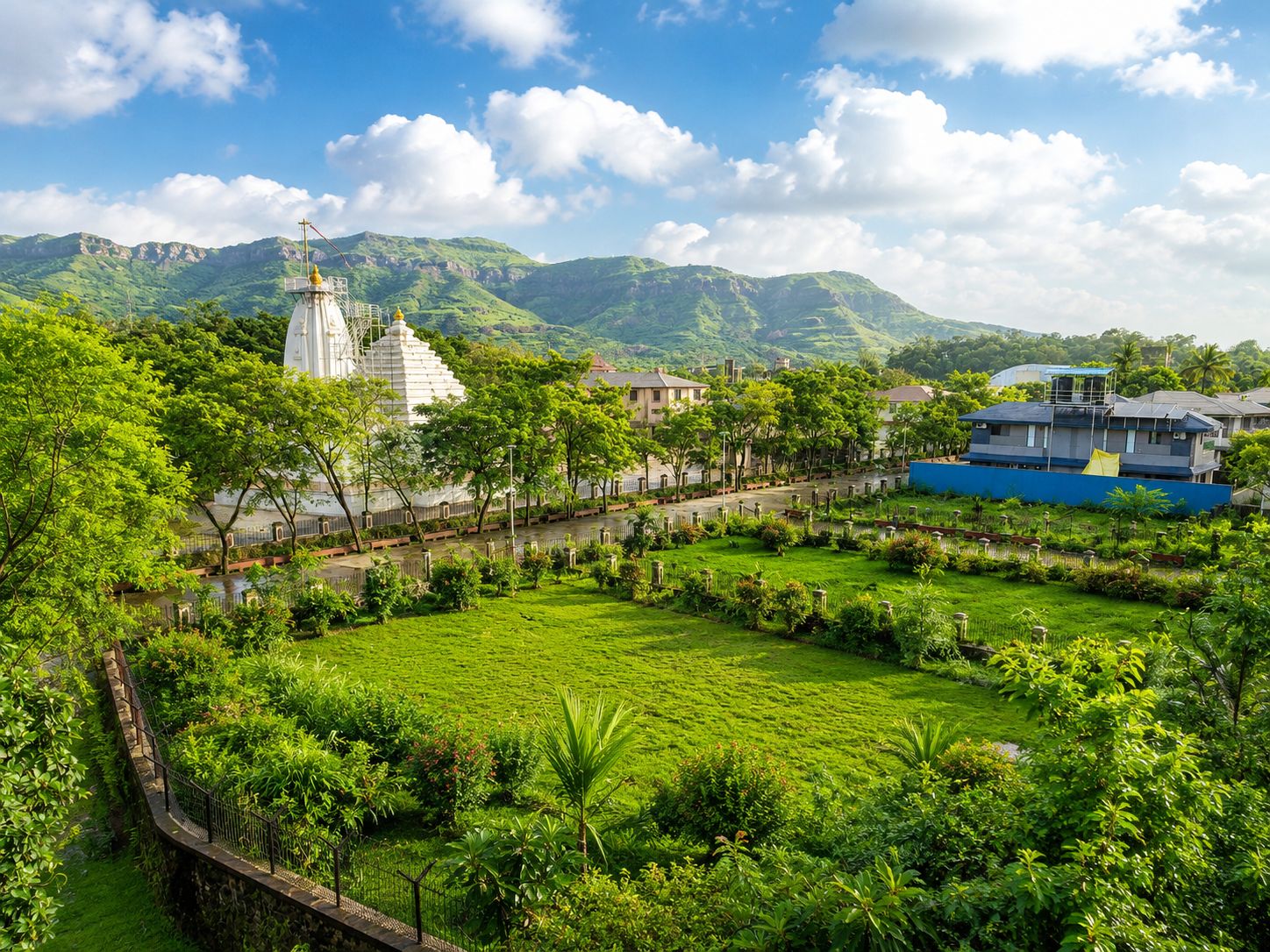 Paisagem verdejante com um templo, um rio e uma área residencial com casas.