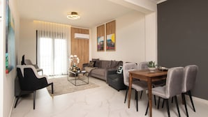Uma sala de estar moderna com sofá, cadeiras, uma mesa de jantar e obras de arte nas paredes.