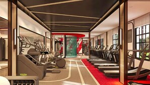 Uma academia com esteiras, elípticos e equipamentos de musculação.