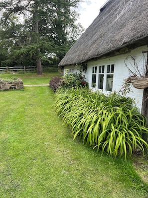15th century thatched farmhouse in picturesque village surrounded by ...