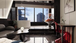 Uma sala de estar moderna com uma janela grande, um sofá, uma mesa e uma cadeira.