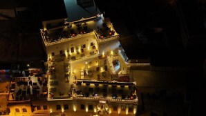 Um edifício de vários andares com um pátio central, varandas e áreas de estar ao ar livre.