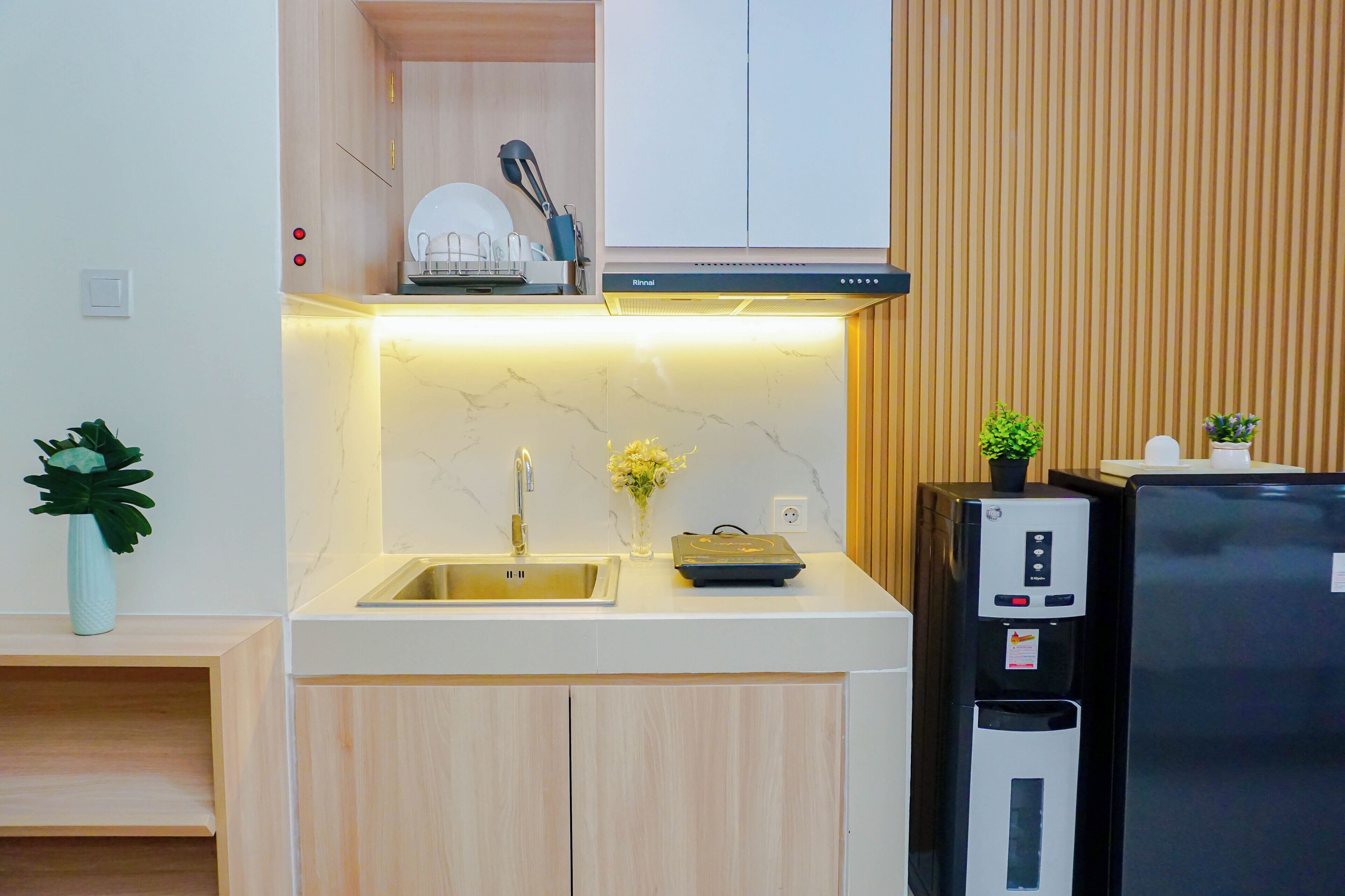 Uma cozinha moderna com pia embutida, fogão e geladeira.