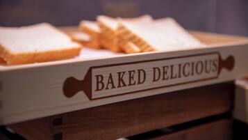 Uma caixa de madeira com a etiqueta 'BAKED DELICIOUS' e fatias de pão.