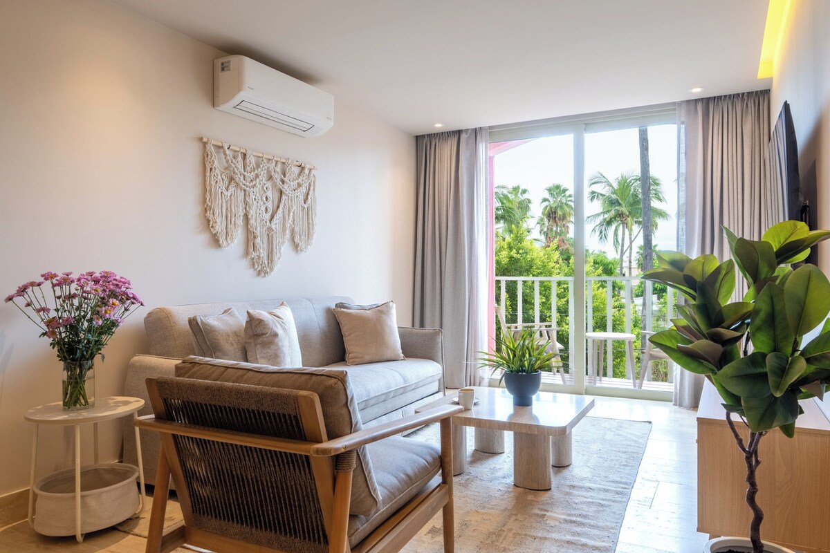 Sala de estar com sofá, mesa de centro e planta.