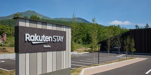 A hotel sign with 'Rakuten Stay Niseko' indicating a location in Niseko.