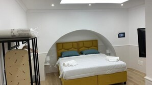 Quarto com cama, escrivaninha e uma cadeira.