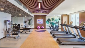 A gym with treadmills, stationary bikes, and weight machines.