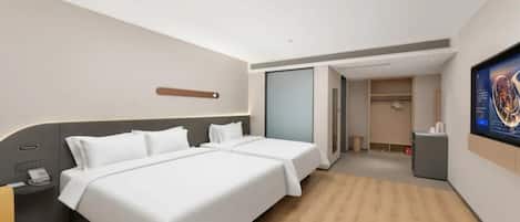 Quarto de hotel com duas camas, uma escrivaninha, uma cadeira, uma televisão e um guarda-roupa.
