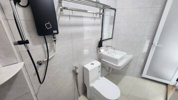 Quarto Duplo Deluxe | Casa de banho | Um polibã, um chuveiro fixo, artigos de higiene pessoal grátis