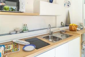 Apartamento, varanda | Cozinha privada