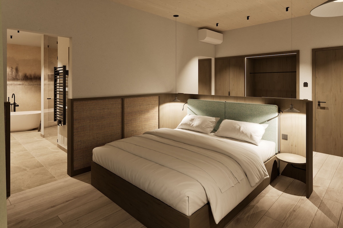 Quarto moderno com uma cama grande, um banco embutido e um closet espaçoso.