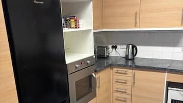 Um frigorífico, um micro-ondas, um forno, uma placa de cozinha