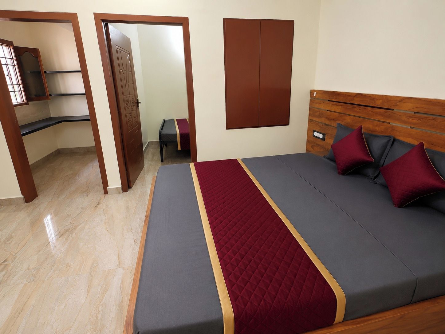 Um quarto com cama, guarda-roupa e escrivaninha.