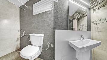 Uma casa de banho moderna com sanita, lavatório e zona de duche.
