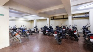 Um parque de estacionamento com várias filas de motociclos estacionados.
