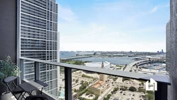 Uma varanda com vista para o horizonte urbano, incluindo uma ponte e corpos d'água.
