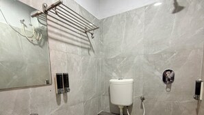 A bathroom with a sink, toilet, and shower.