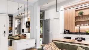 A modern kitchen with a dining area, a sofa, and a chessboard.