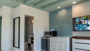A modern kitchen with white cabinetry, a microwave, and a built-in oven.
