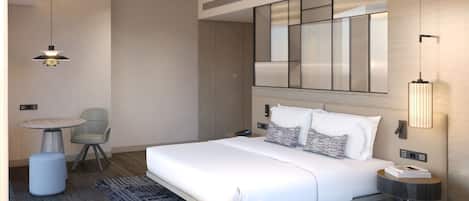 Quarto de hotel moderno com uma cama grande, uma mesa redonda, uma cadeira e um espelho fixado na parede.