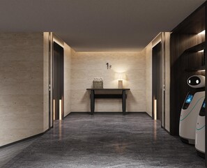 Um corredor moderno com piso de mármore, uma mesa com abajur e um robô à direita.