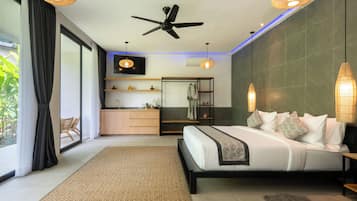 Quarto moderno com cama grande, ventoinha no teto e televisão na parede.