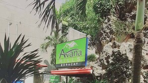 Placa indicando Avana Hills Boracay, rodeada por vegetação exuberante e palmeiras.