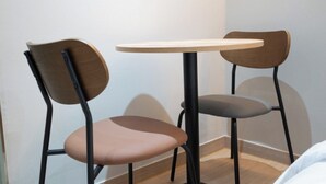 A corner of a room with two chairs and a small table.