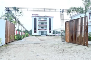 A gated entrance to a building with a sign reading 'HOTEL VIRAJ.'