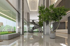 Um lobby moderno com uma escada espiral, área de estar e uma grande janela com vista para o verde.