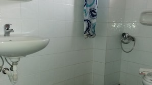 A bathroom with a white sink, a toilet, and a shower curtain.
