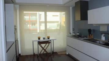 Uma cozinha moderna com área de jantar, janela com vista e armários embutidos.