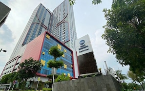 Um hotel com design moderno, exibindo uma placa Best Western e uma grande fachada de vidro.