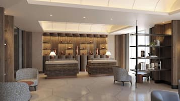 Um lobby moderno com balcão de recepção, área de estar e estante de livros.