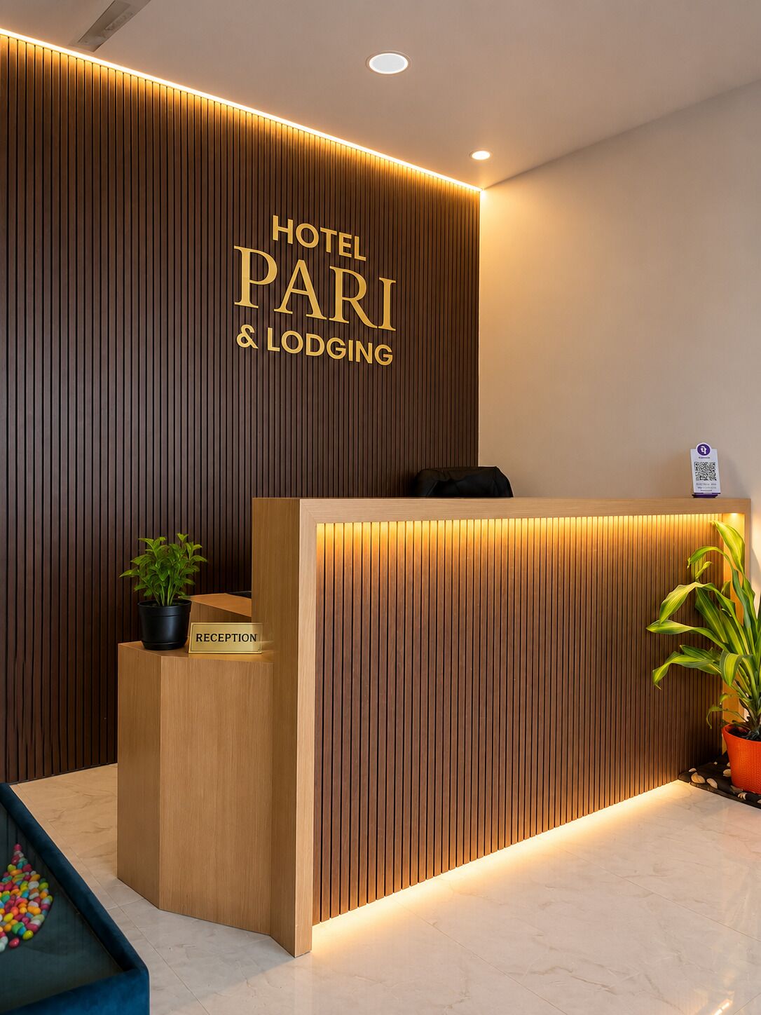 Bancada de recepção com acabamento em madeira e uma placa com a inscrição 'HOTEL PARI & LODGING'.