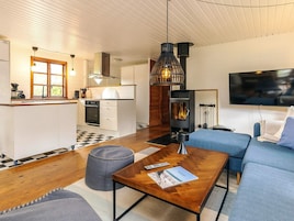 Uma sala de estar moderna com sofá, mesa de centro e lareira.