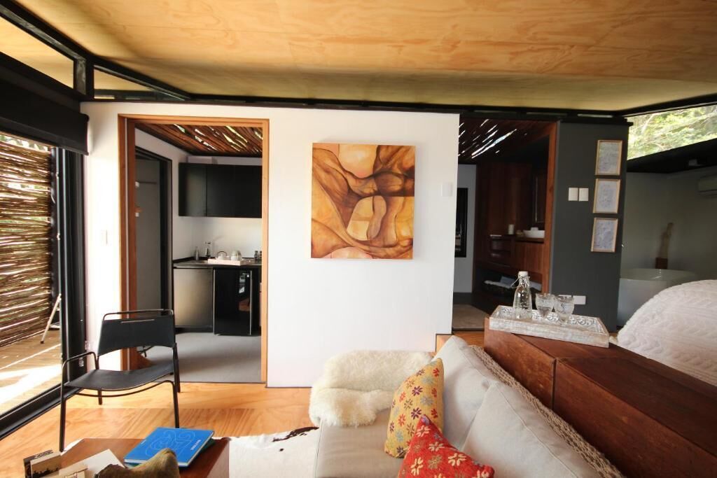 Um interior moderno com um sofá, um quadro e uma área de jantar.