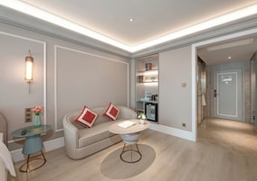 Uma sala de estar moderna com um sofá, uma mesa de centro e uma estante de livros.