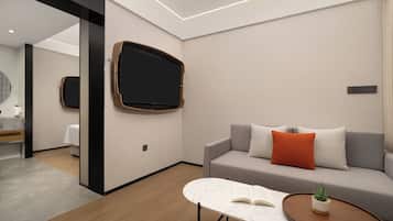 Uma sala de estar moderna com um sofá, uma mesa de centro e uma televisão na parede.