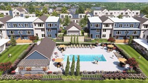 Um complexo residencial com piscina central, várias casas e um gramado bem cuidado.