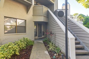 Um edifício residencial com área externa coberta, escadaria e diversos tipos de plantas.